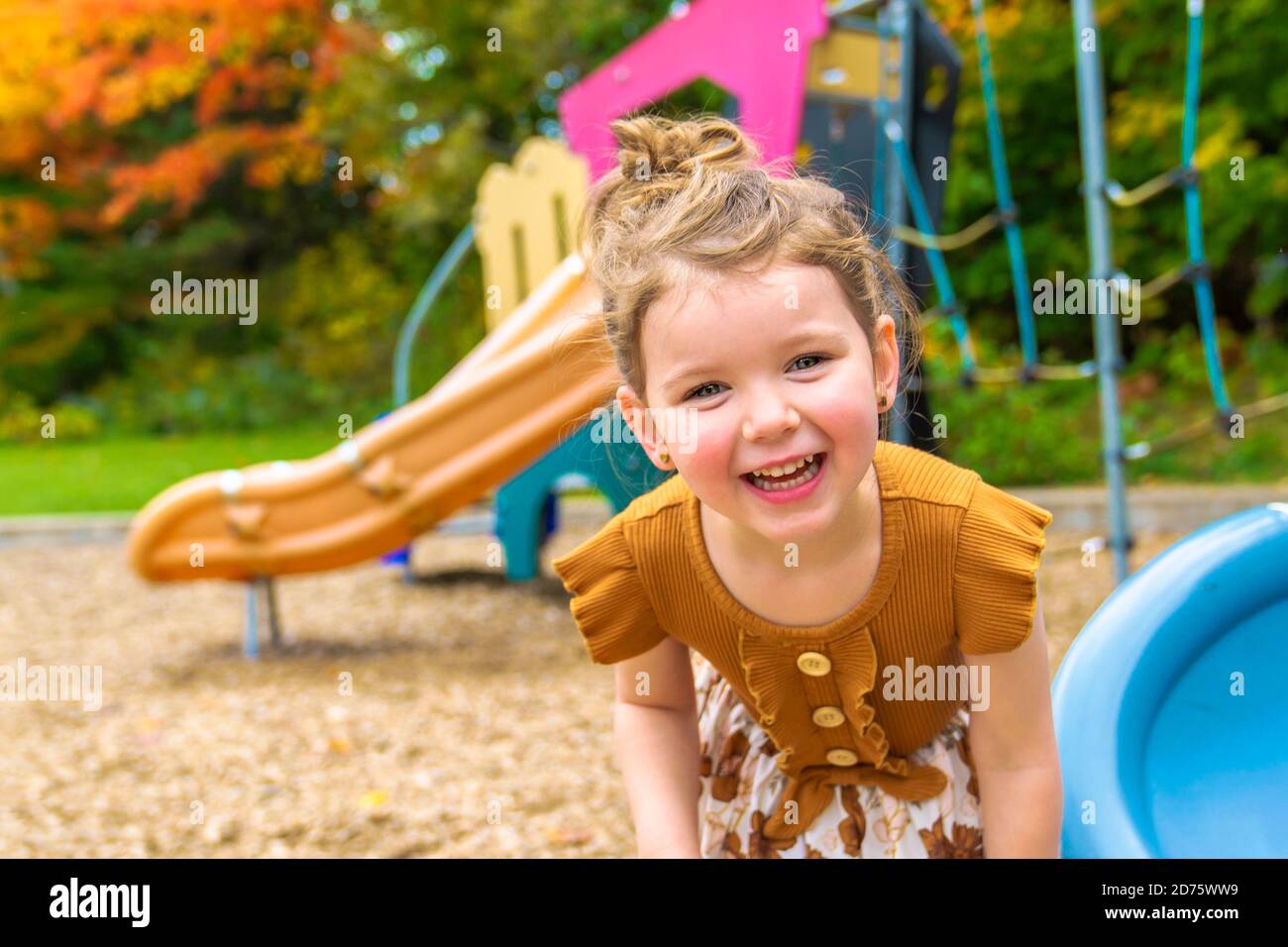 Happy Smiling Child Girl Playing At Playground Outdoors In a nice Park ...