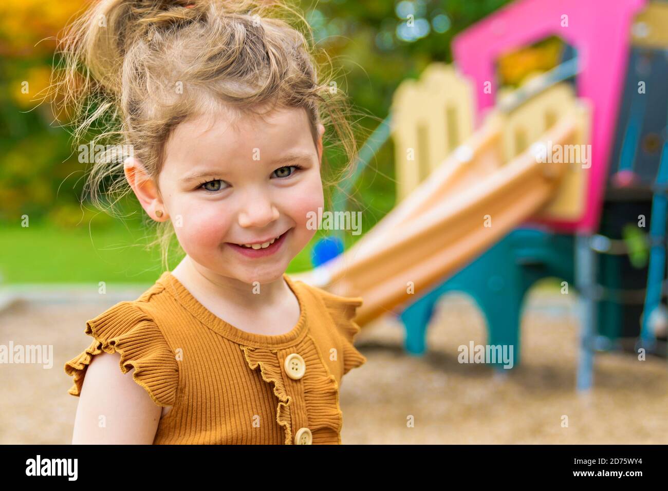 Happy Smiling Child Girl Playing At Playground Outdoors In a nice Park ...
