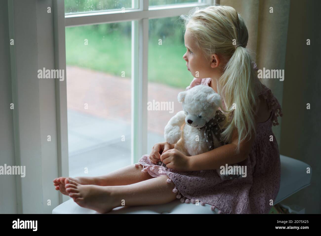 Sad girl looking out window white hi-res stock photography and images ...