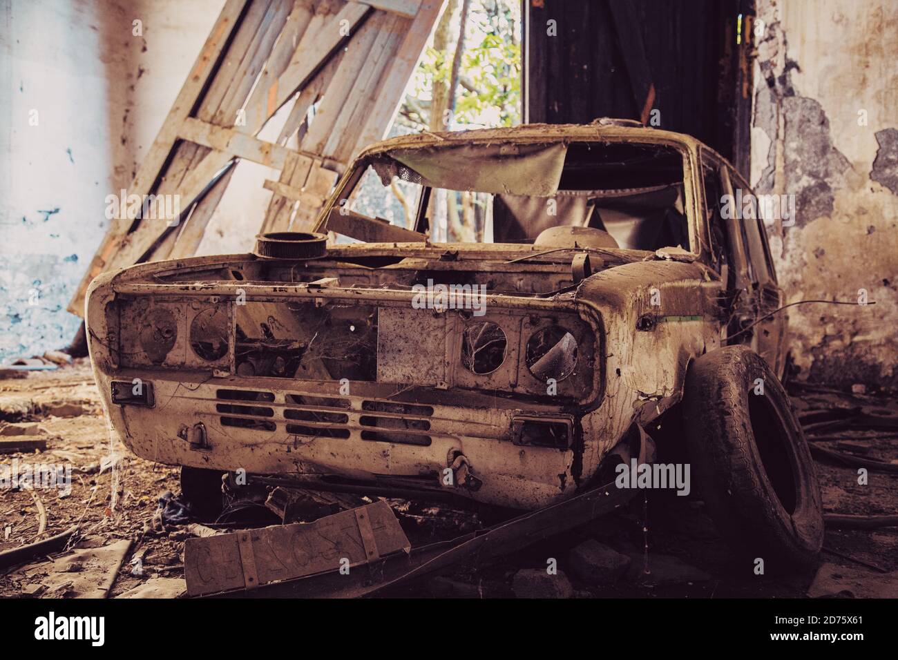 Front of old scrapped car in abandoned garage Stock Photo - Alamy