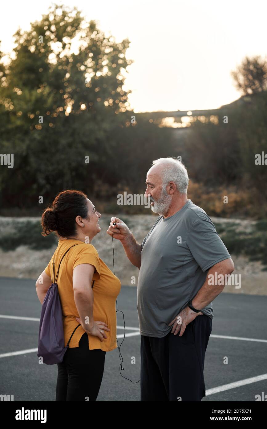 An elderly couple is sharing a headset for sport Stock Photo - Alamy
