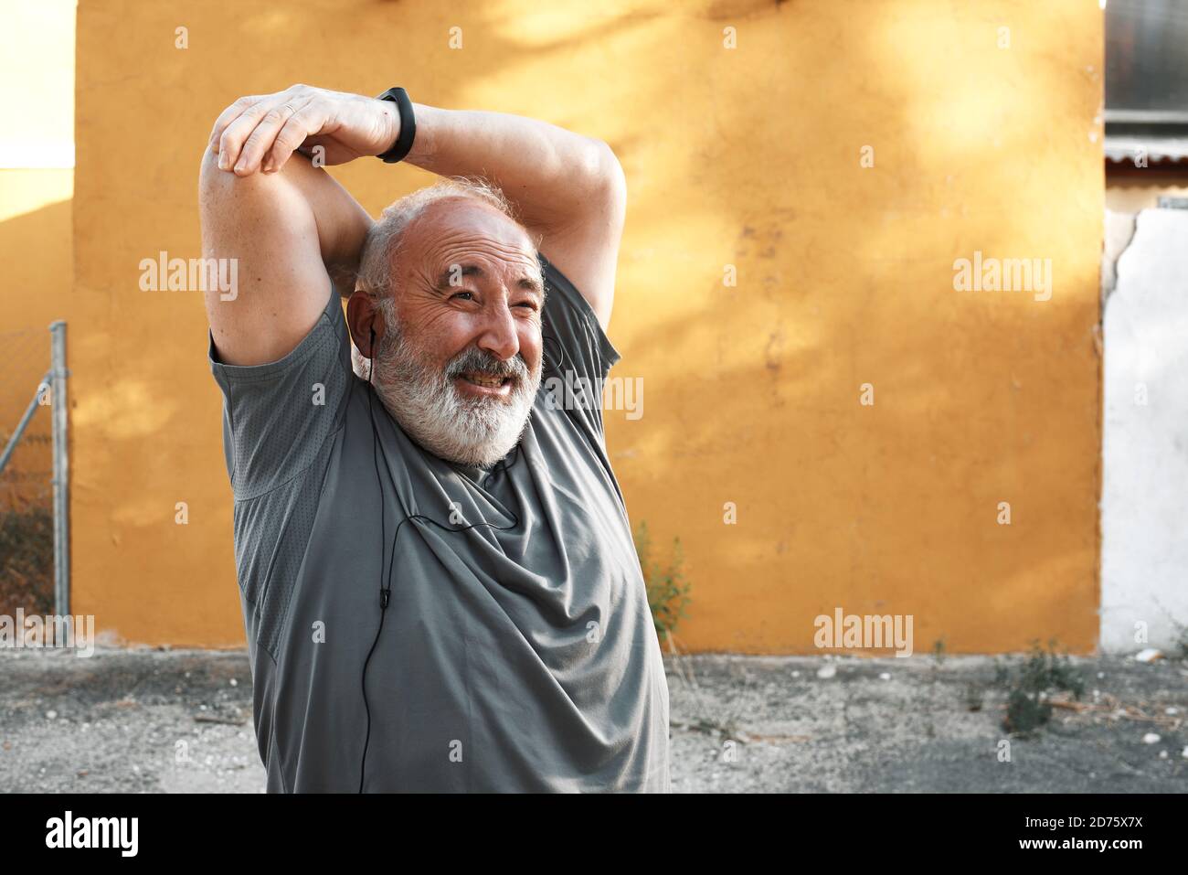 An old man is stretching out his arm with a sore face Stock Photo - Alamy