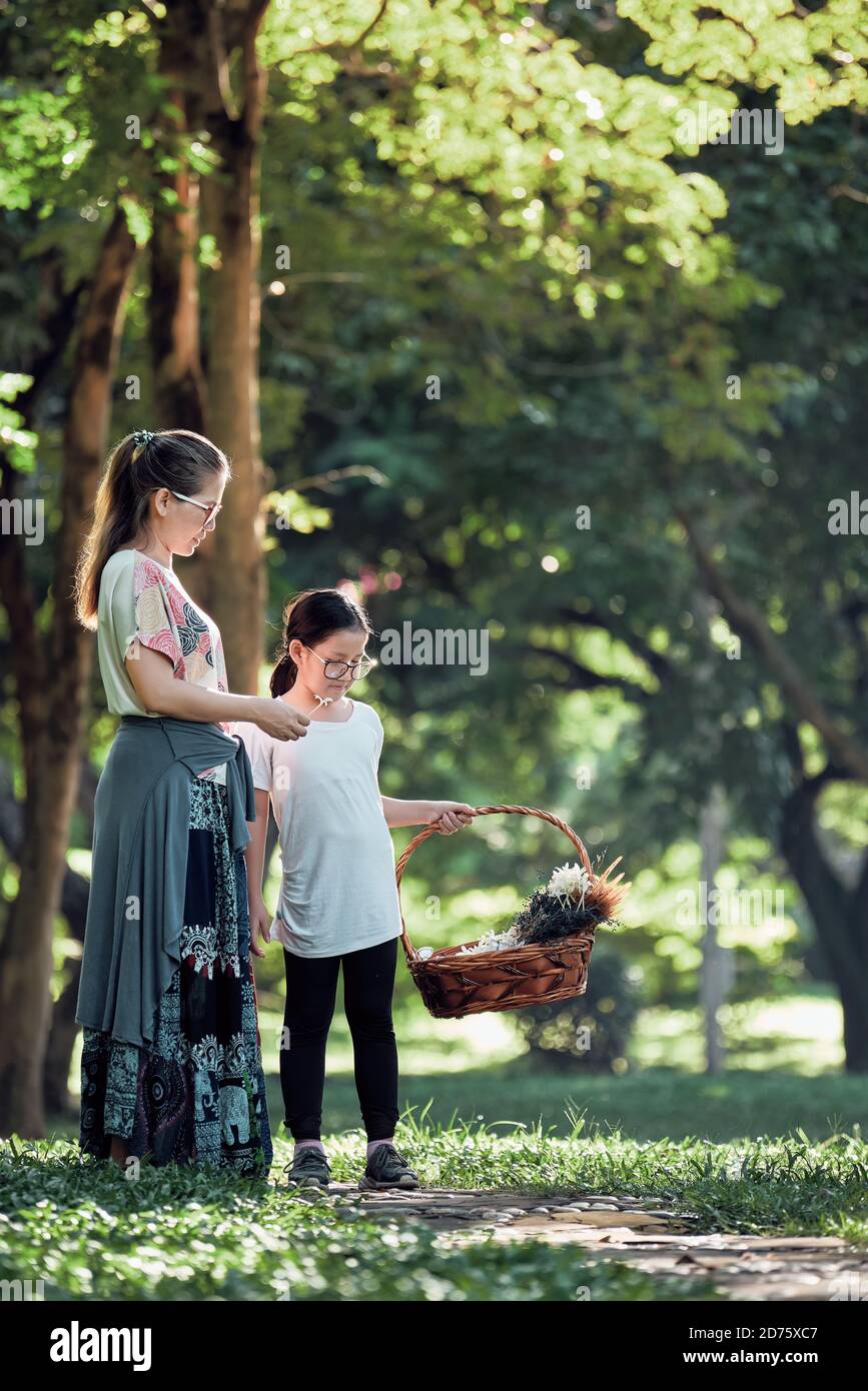 Mother and daughter picking flowers in the park Stock Photo - Alamy