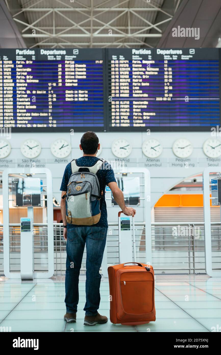 Young man waiting his flight at the airport Stock Photo - Alamy