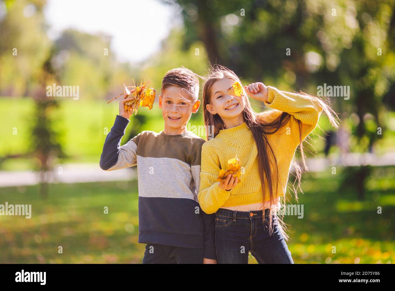 Friendship between siblings. Siblings together outside with bright ...