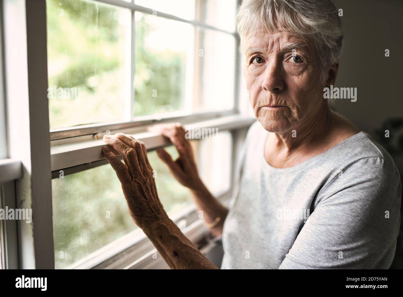 Woman house window worried hi-res stock photography and images - Alamy