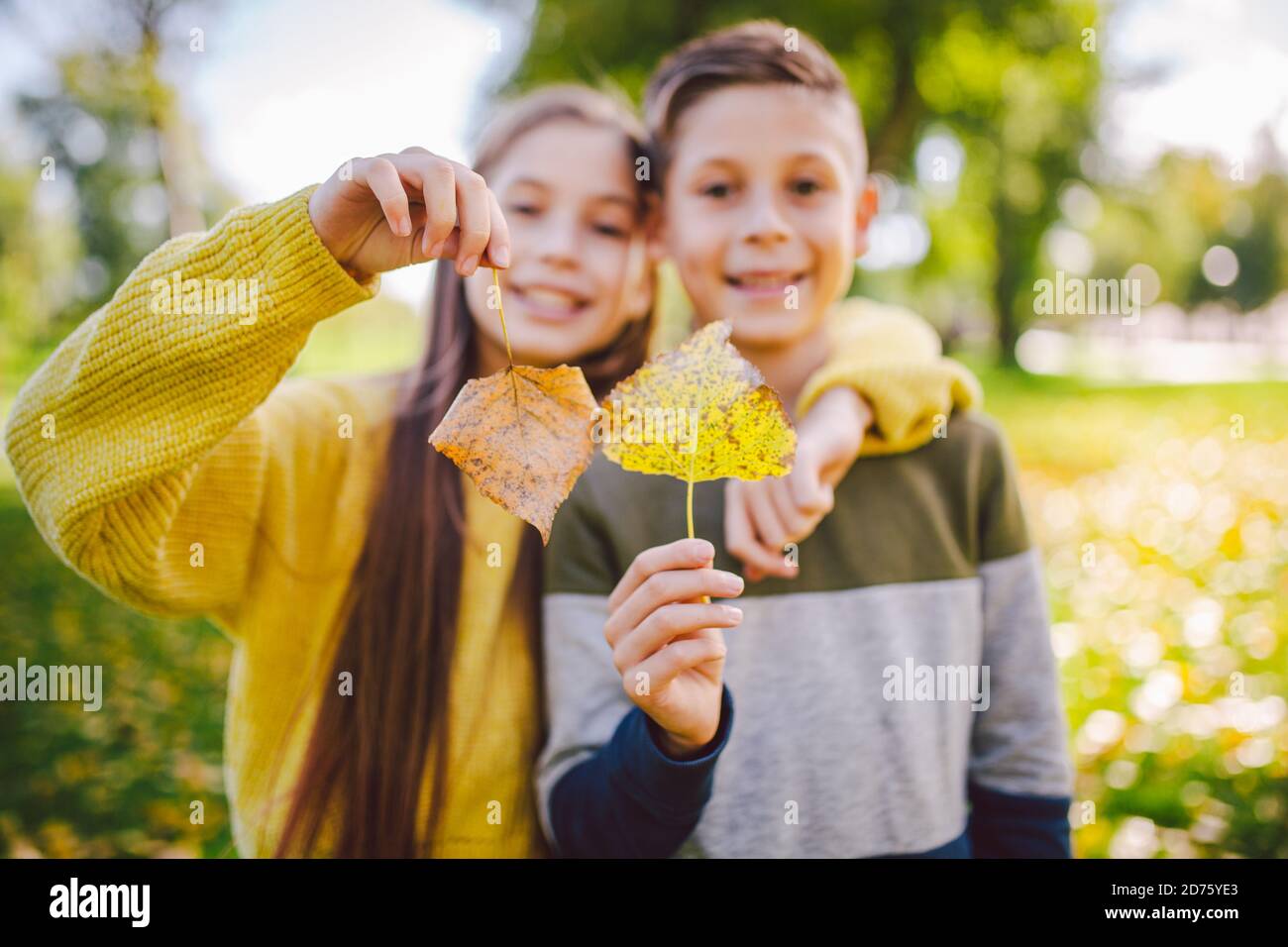 Friendship between siblings. Siblings together outside with bright ...