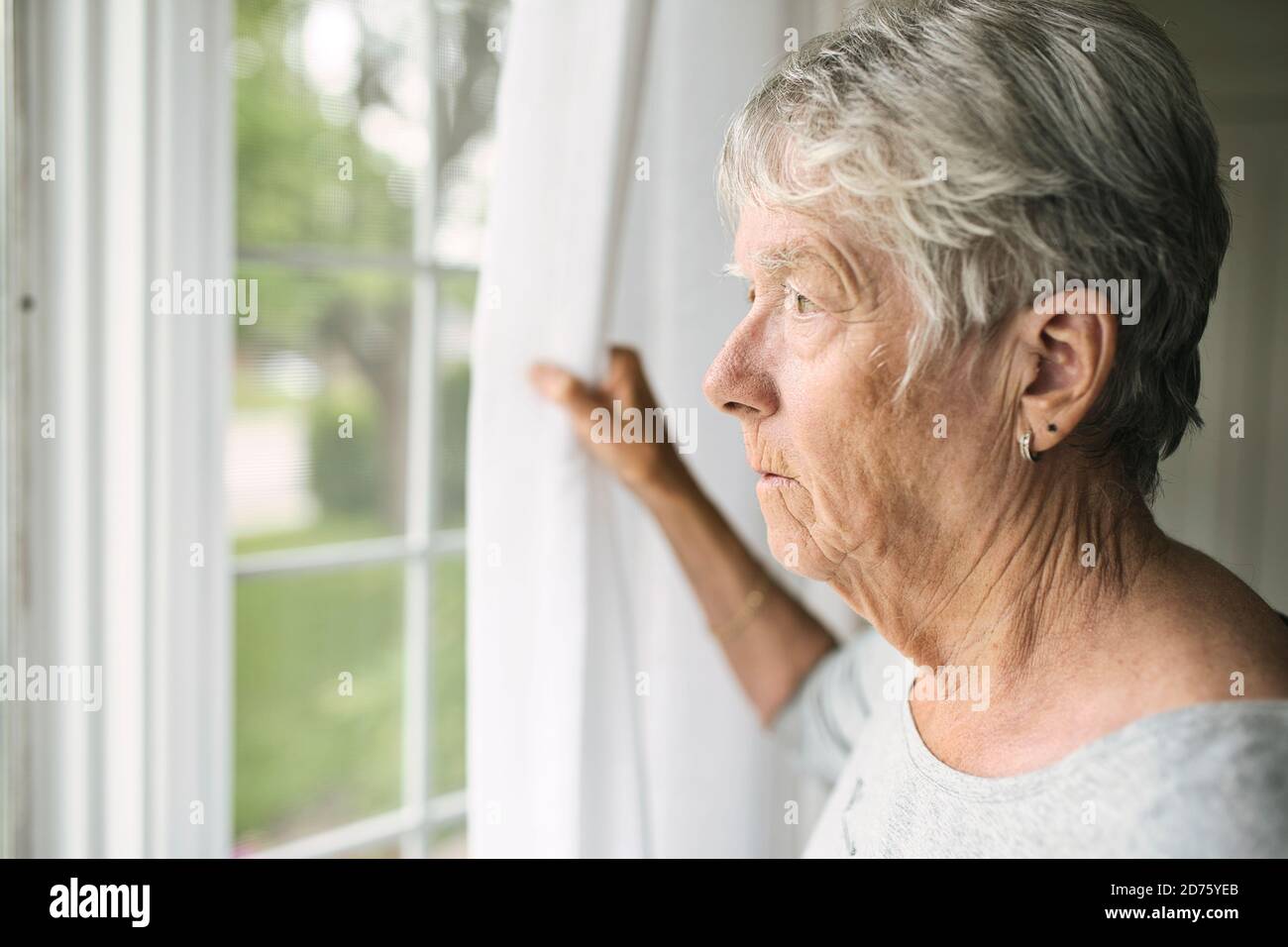Woman house window worried hi-res stock photography and images - Alamy