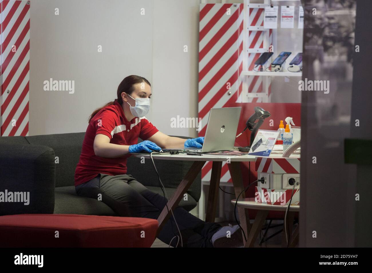 BELGRADE, SERBIA - OCTOBER 5, 2020: Young Woman staff worker of a phone ...