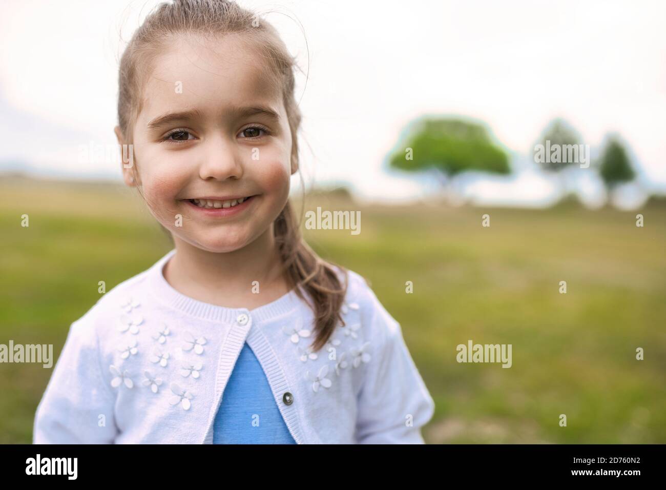 cute Portrait of a nice little girl outside Stock Photo - Alamy