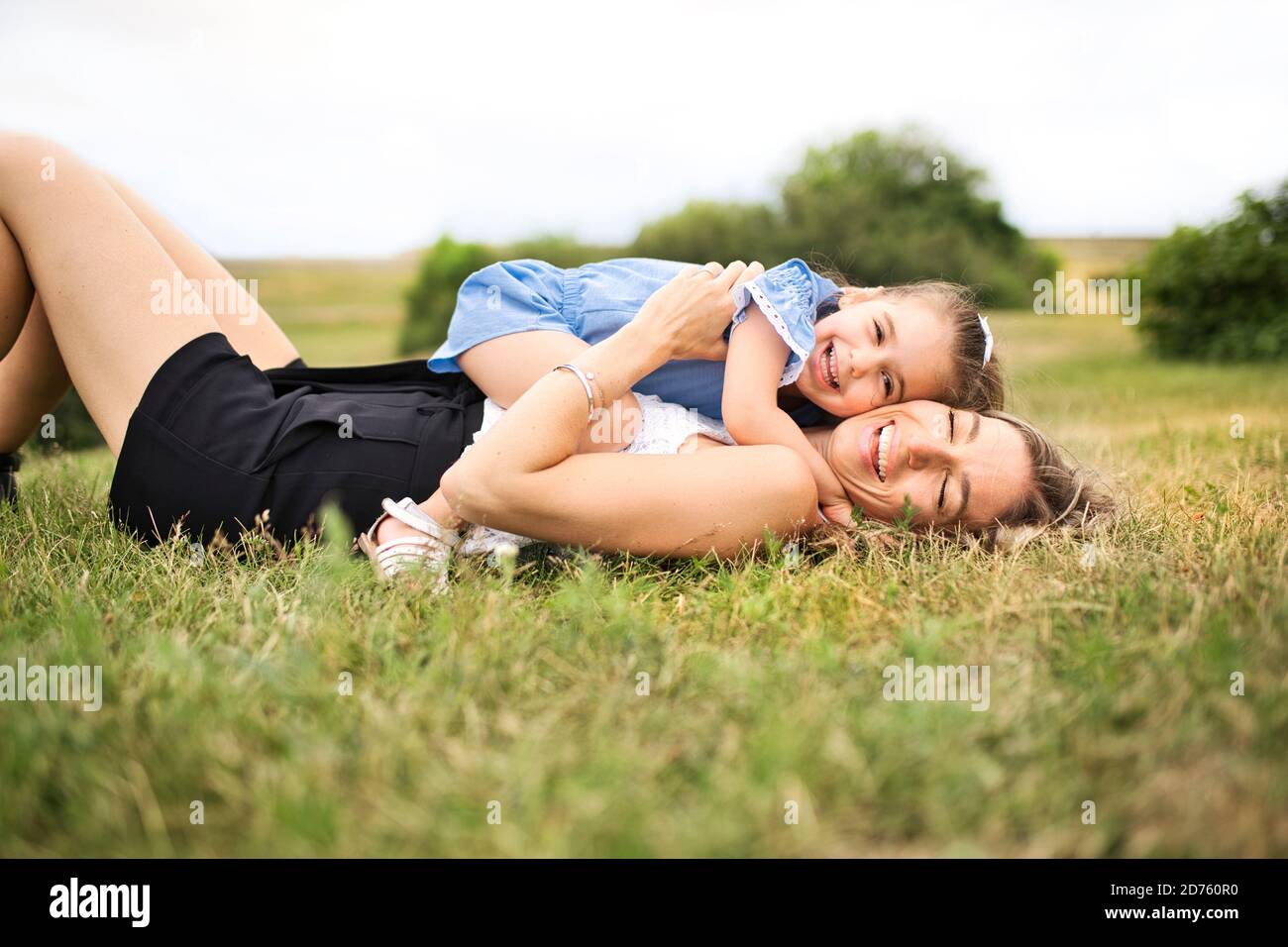 Happiness mother with her daughter lay on the ground Stock Photo - Alamy