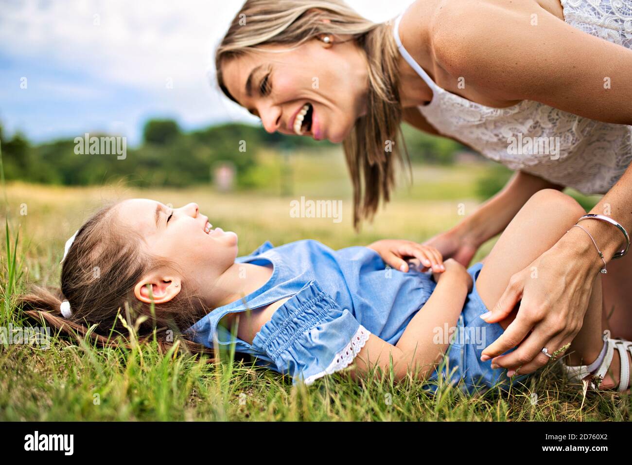 Happiness mother with her daughter lay on the ground Stock Photo - Alamy