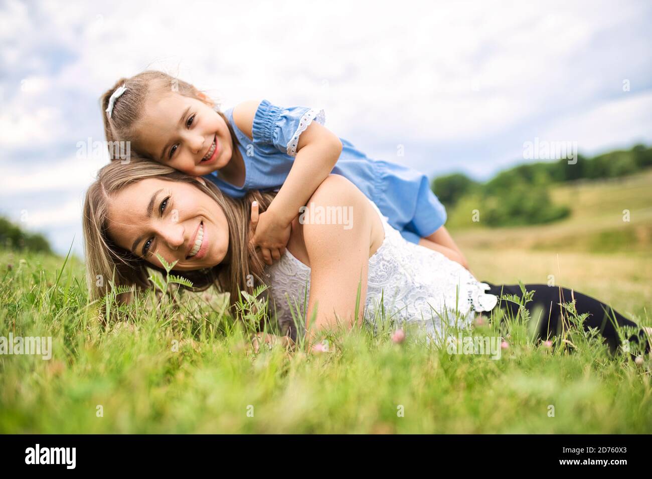 Happiness mother with her daughter lay on the ground Stock Photo - Alamy