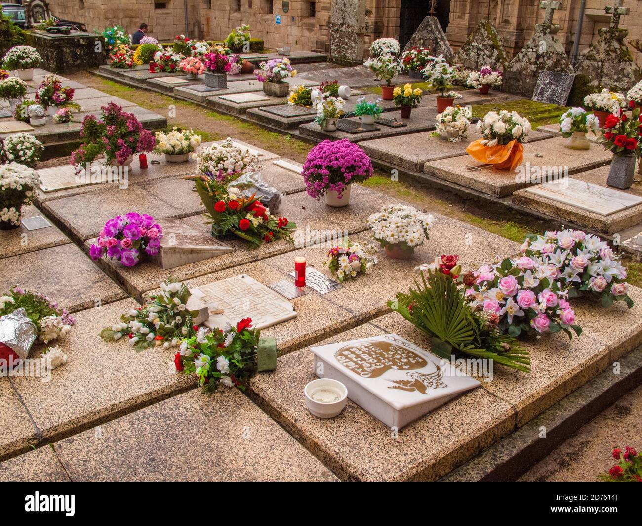 Flowers on tombstones in graveyard in Galicia, Spain Stock Photo - Alamy