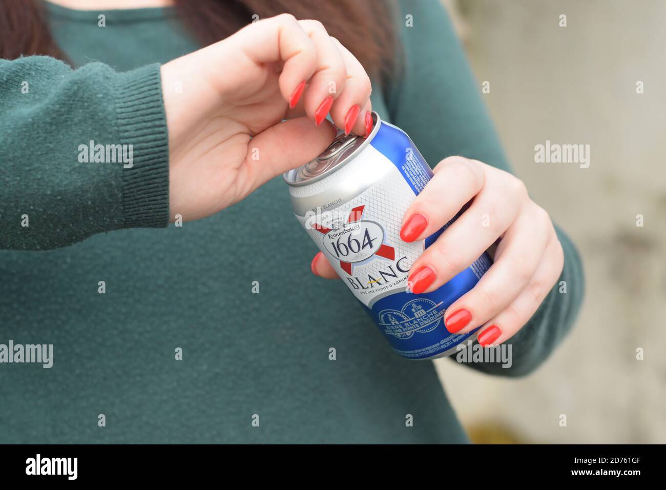 KHARKOV, UKRAINE - OCTOBER 16, 2020: Young girl holds 1664 Kronenbourg ...