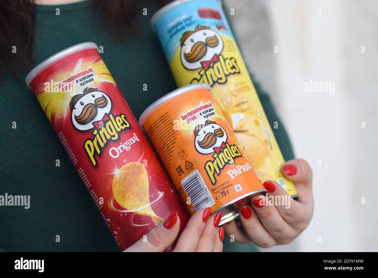 KHARKOV, UKRAINE - OCTOBER 16 2020: Young girl holds few pringles ...