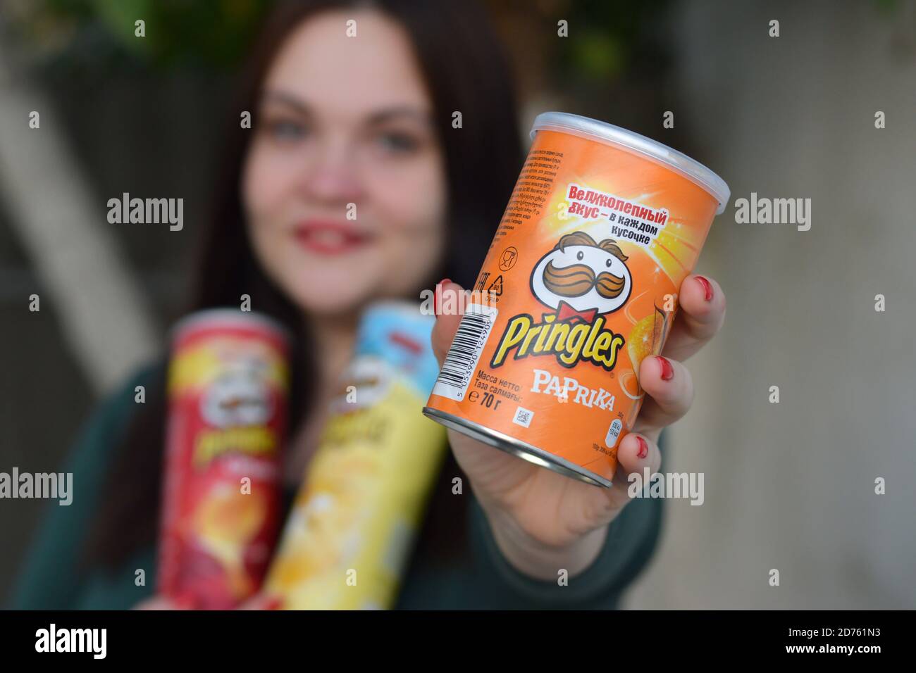 KHARKOV, UKRAINE - OCTOBER 16 2020: Young girl holds few pringles ...