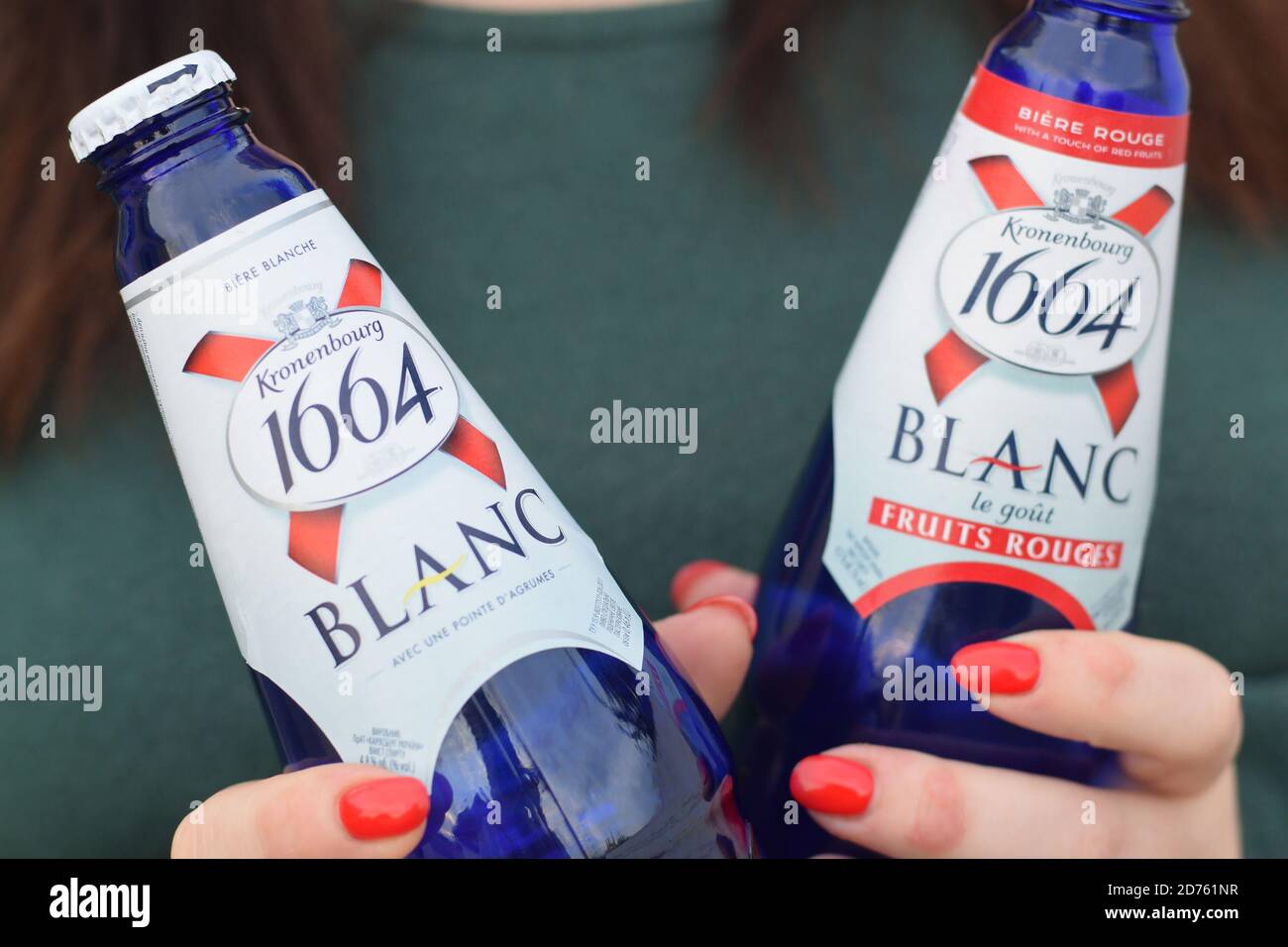 KHARKOV, UKRAINE - OCTOBER 16, 2020: Young girl holds 1664 Kronenbourg ...