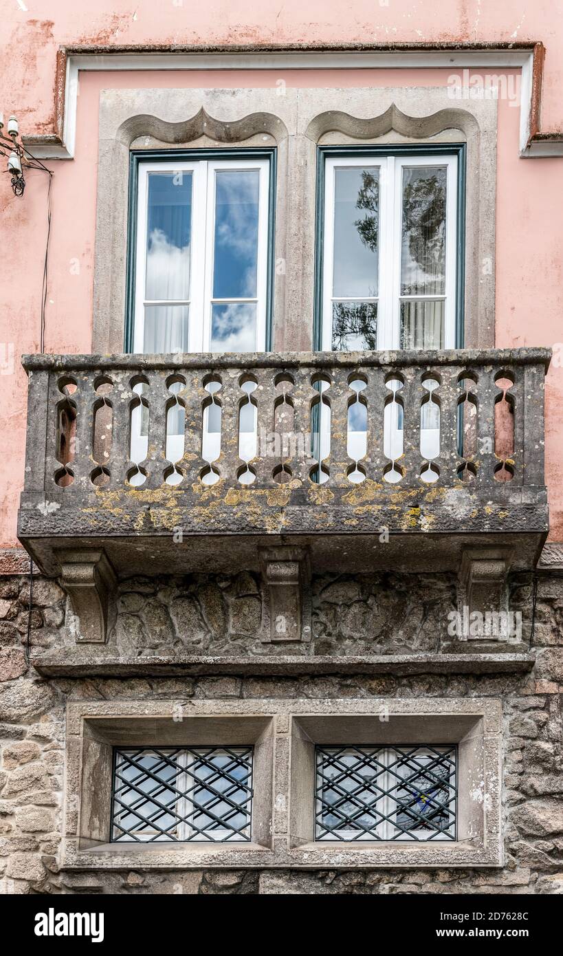 Windows with balcony in old pink house in Sintra, Portugal Stock Photo ...