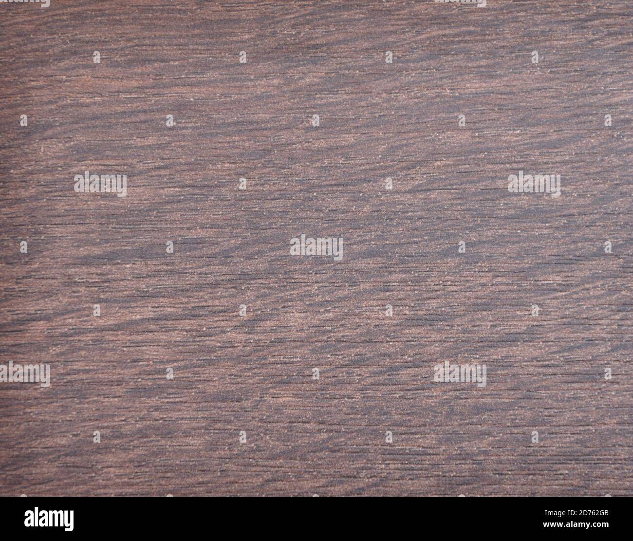 Dark walnut with a red tint, surface treated natural wood surface close ...