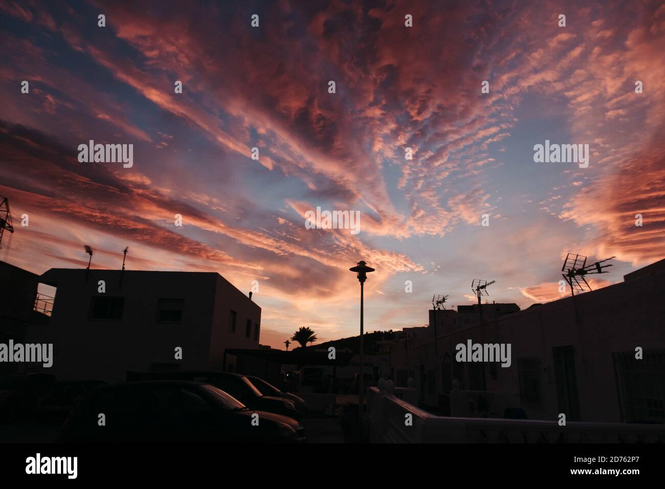 Beautiful scenery of the sunset sky over buildings Stock Photo - Alamy
