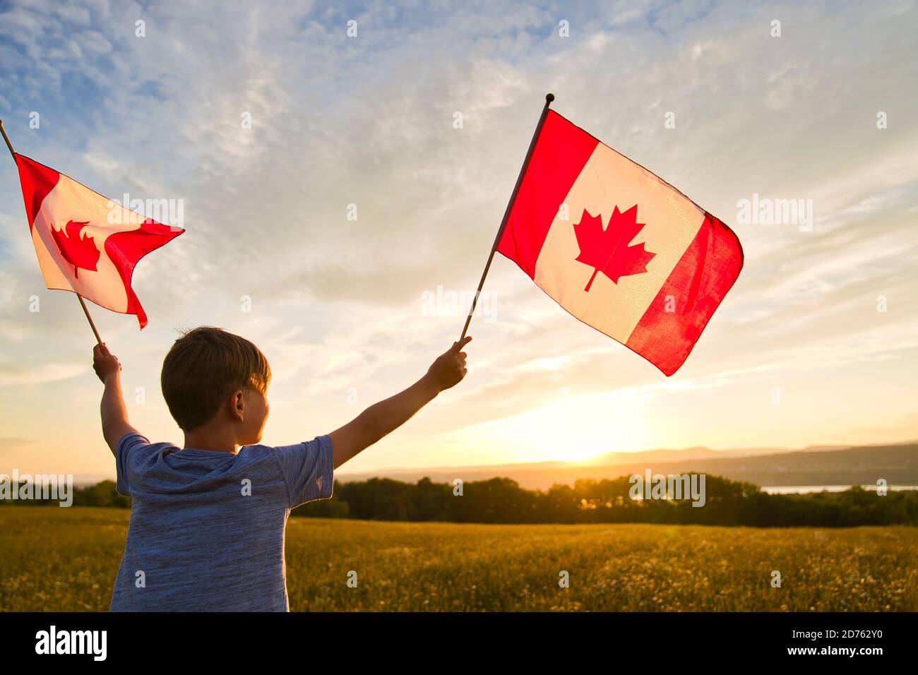 Adorable cute happy Caucasian boy holding Canadian flag on the father ...