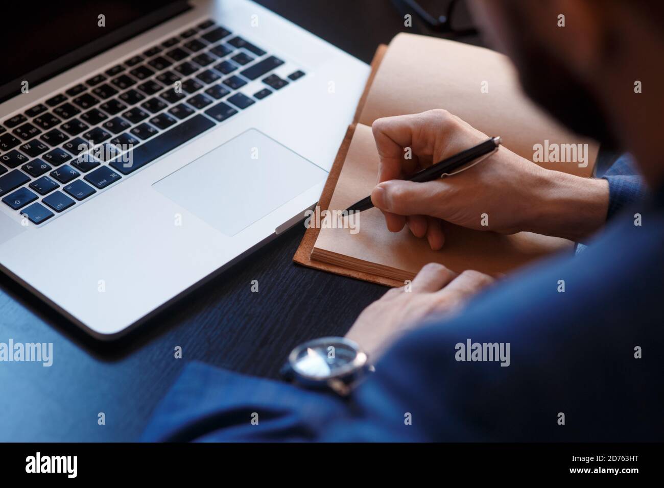 Businessman writing note with pen inspired ideas list on notepad while ...