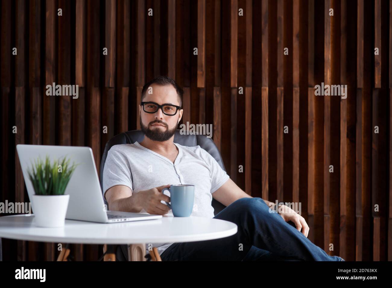 Young successful bearded businessman freelancer in office coworking ...