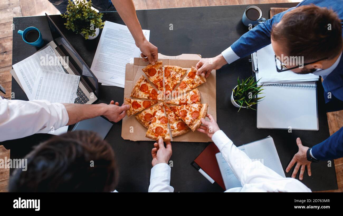 Happy Diverse Colleagues Spend Work Break Together Eating Takeaway
