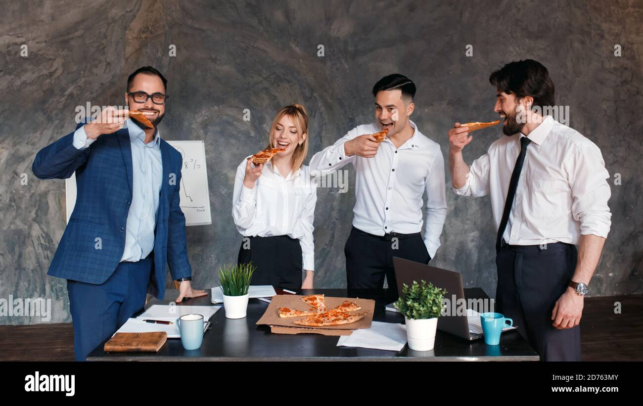 Happy Diverse Colleagues Spend Work Break Together Eating Takeaway