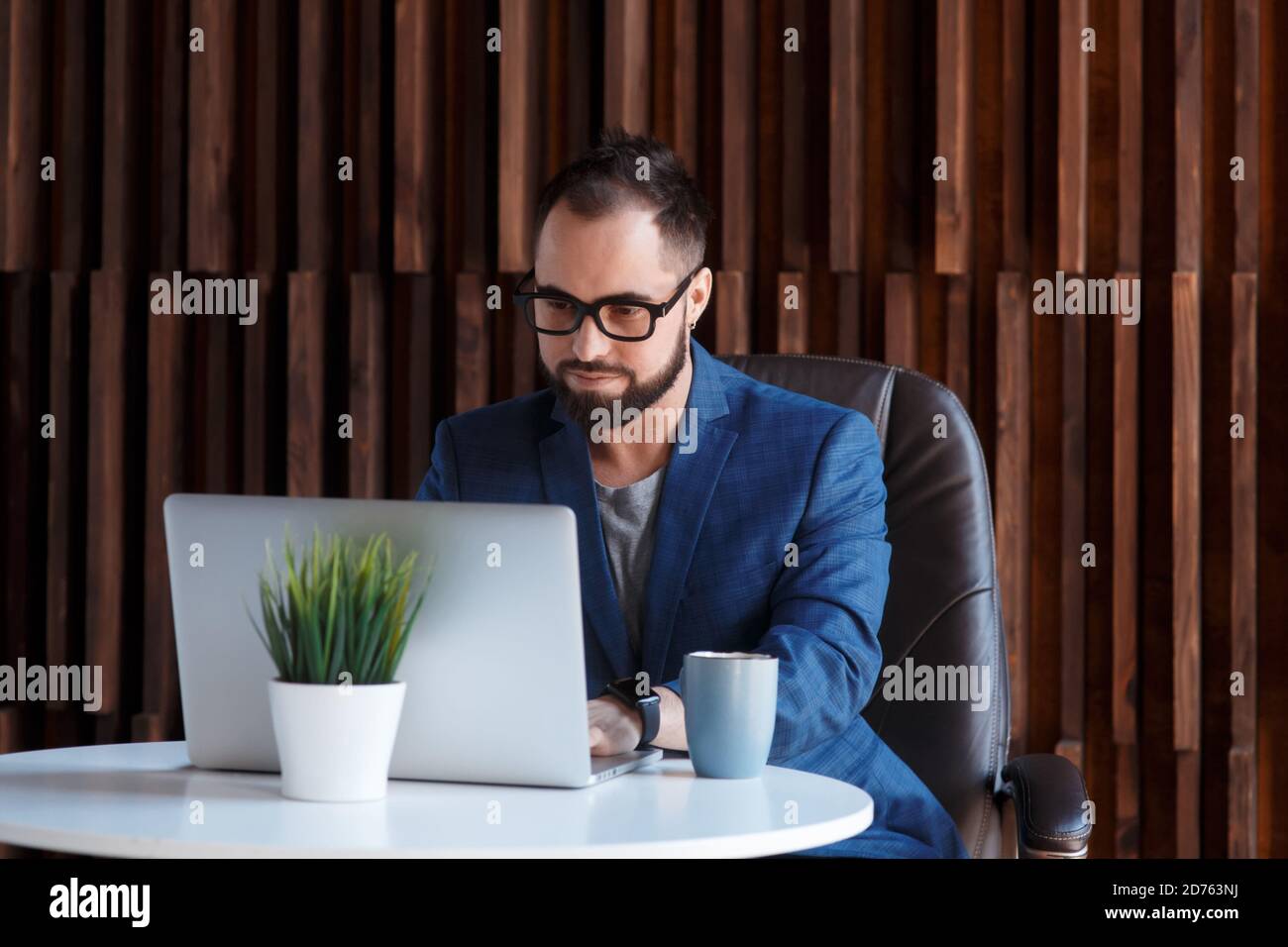 Young successful bearded businessman freelancer in office coworking ...