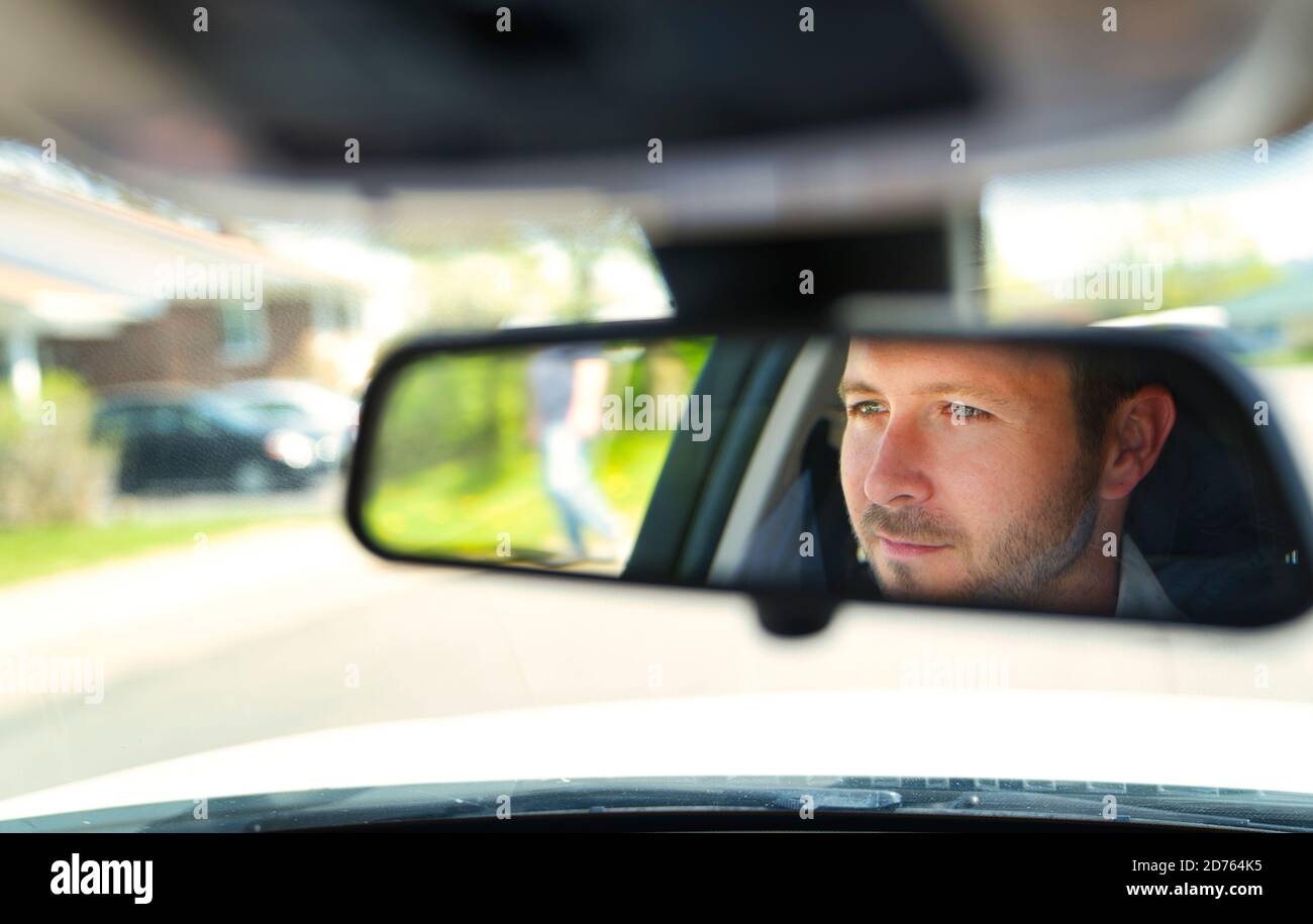 A Portrait of man on his car look nice view from mirror Stock Photo - Alamy