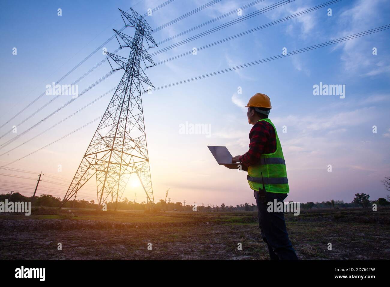 electrical engineer standing and watching at the electric power station ...
