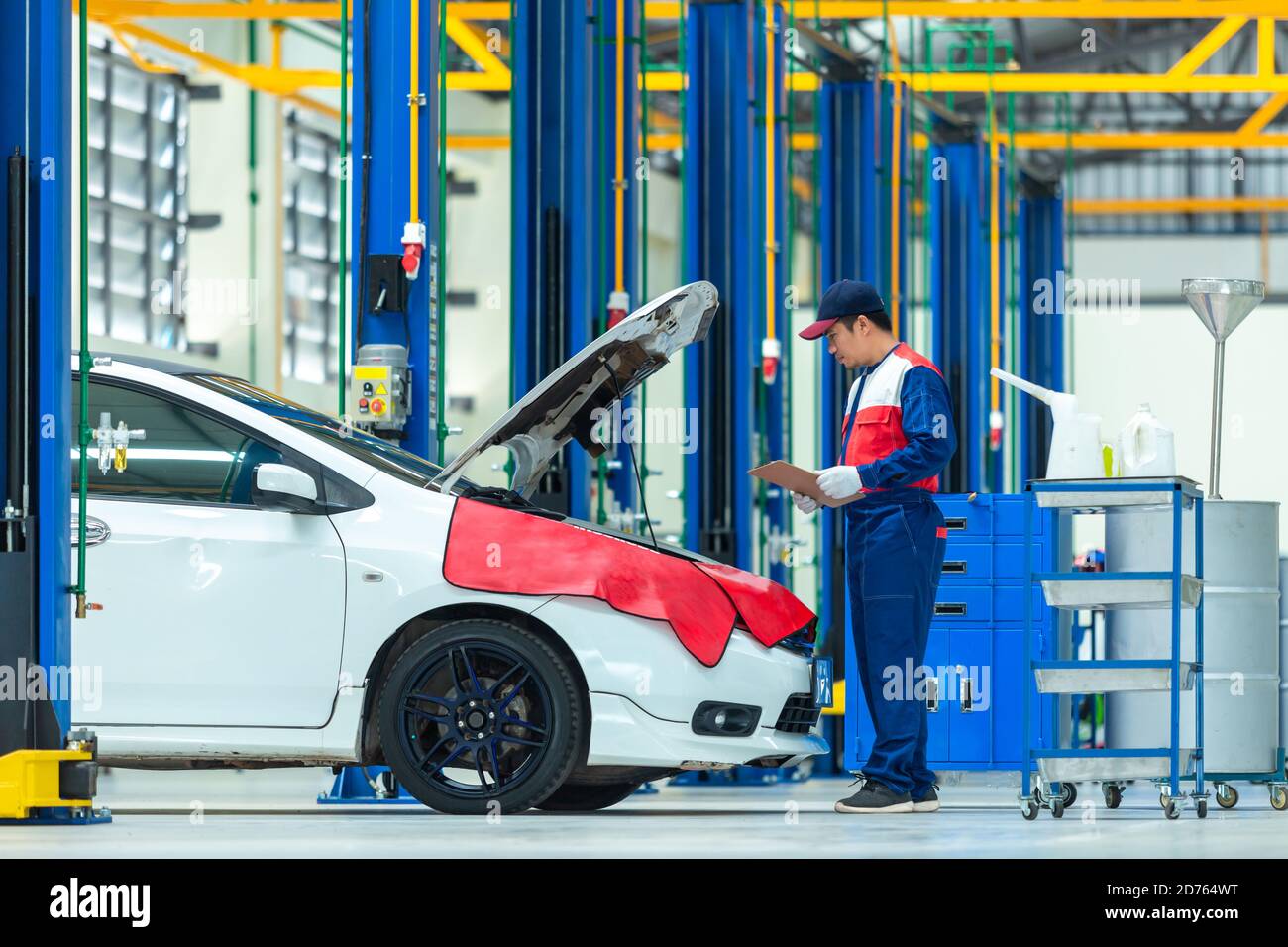 Auto mechanic working in car auto repair service center Stock Photo - Alamy