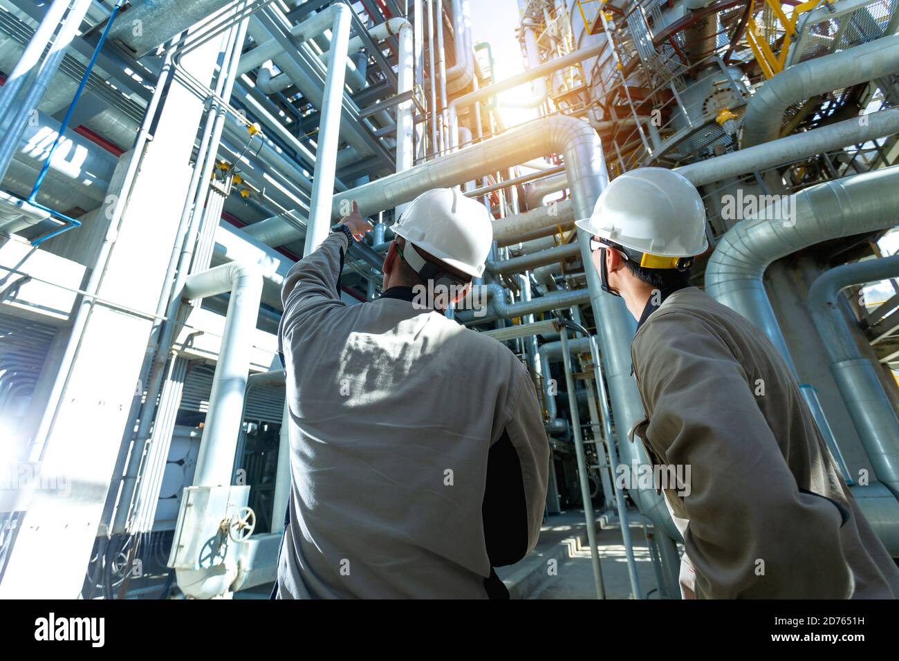 Industrial engineer or worker checking pipeline at oil and gas refinery ...