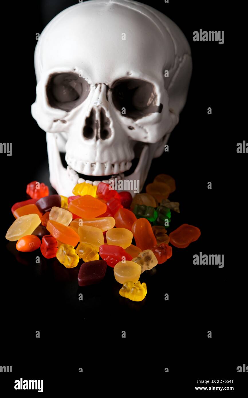 Skeleton Skull with Candy to eat during Halloween Stock Photo - Alamy