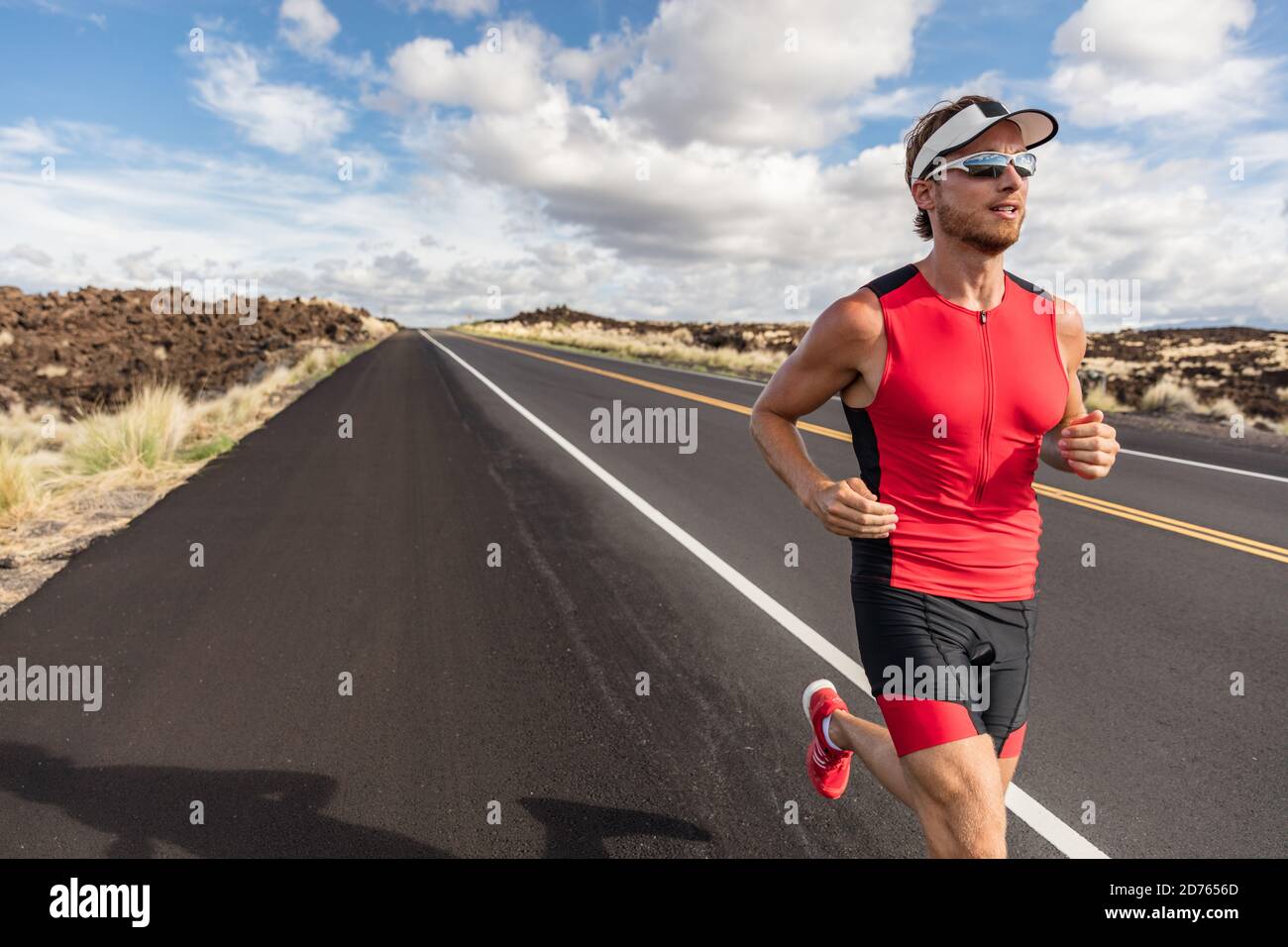 Runner fit athlete man running in triathlon suit training for Iron man ...