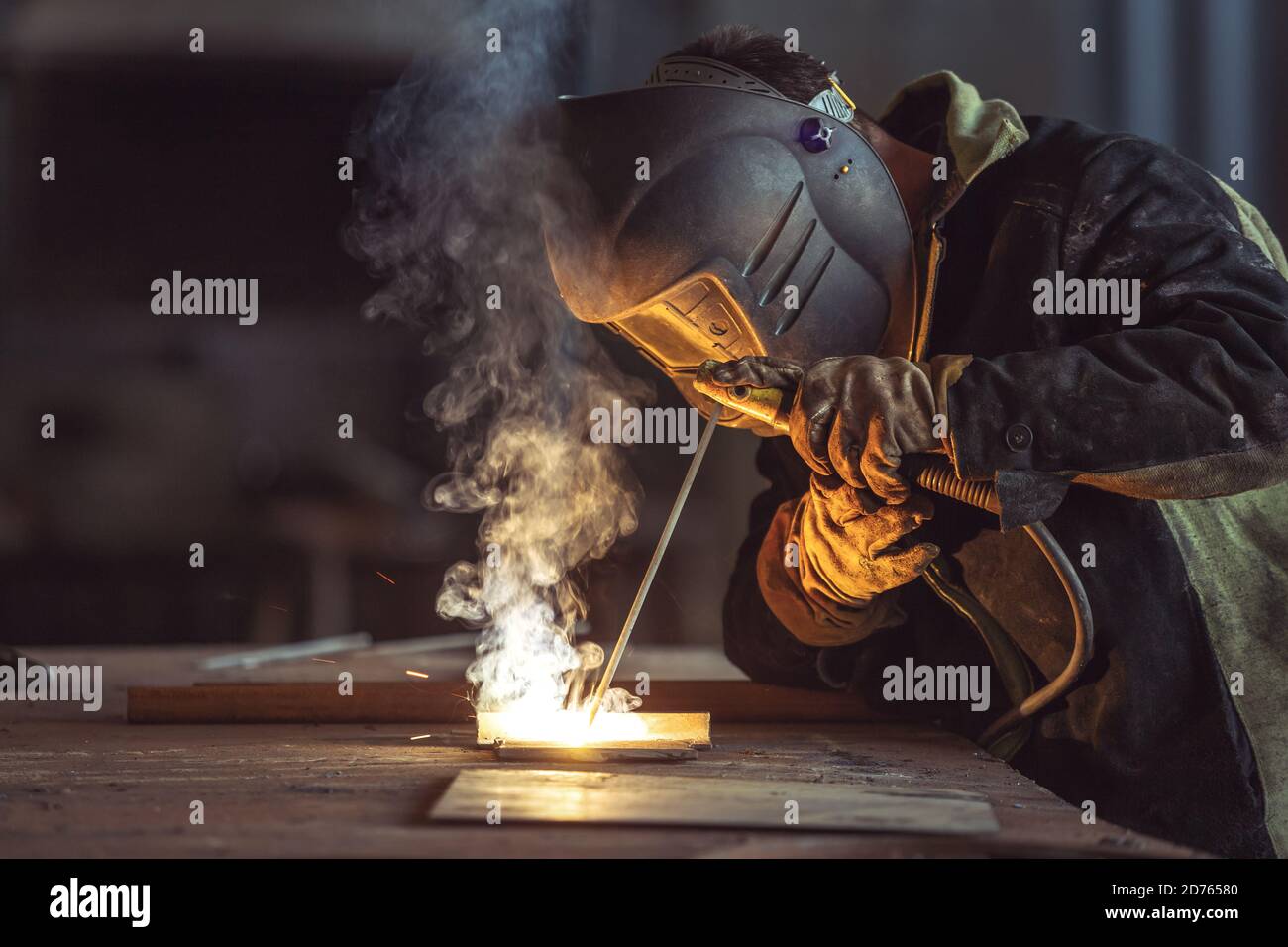 Industrial worker labourer wear a safety mask and safety gloves at the ...