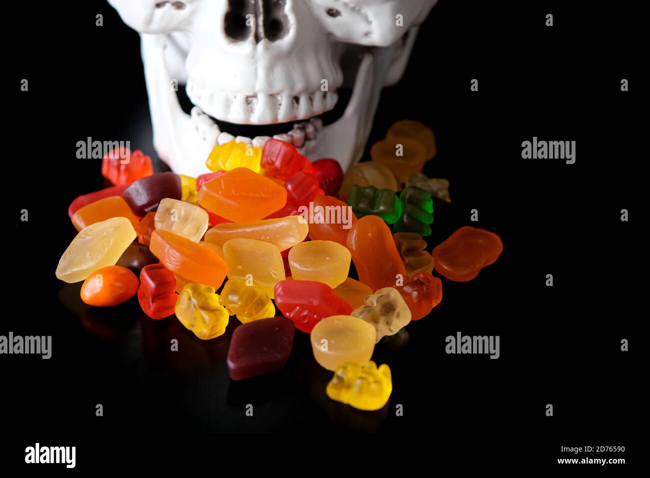 Skeleton Skull with Candy to eat during Halloween Stock Photo - Alamy