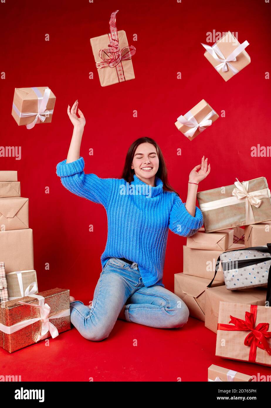 gifts fly to the girl from all sides on a red background Stock Photo ...