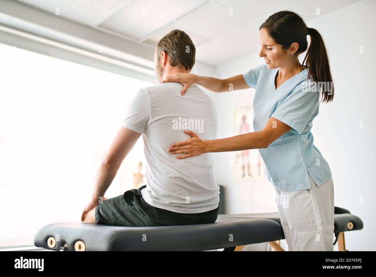 physiotherapist doing treatment with patient in bright office Stock ...