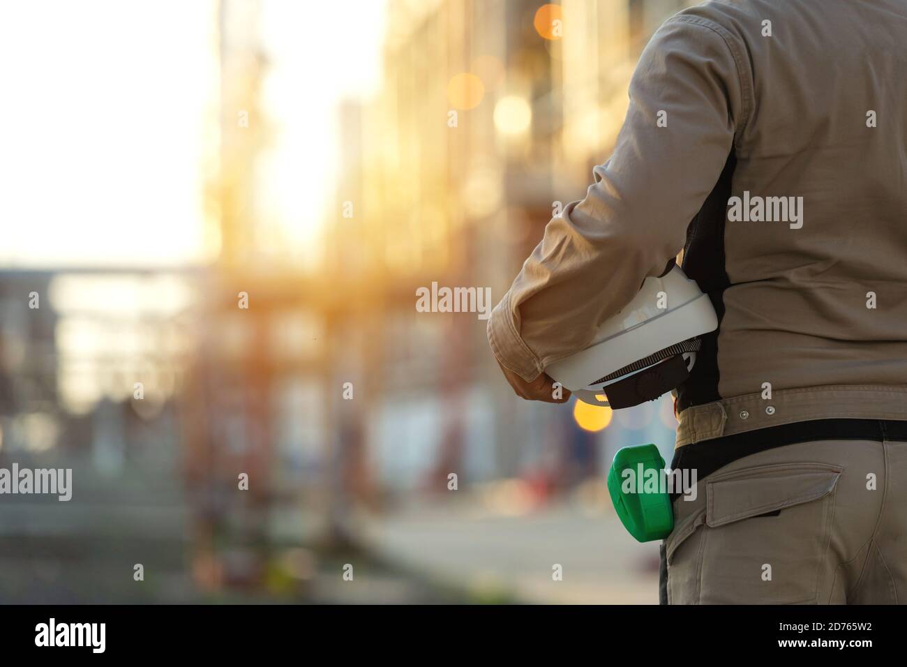 Refinery Industrial engineer stand hold helmet in oil and gas refinery ...