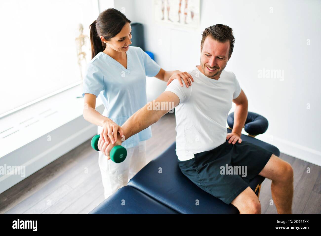 physiotherapist doing treatment with patient in bright office Stock ...
