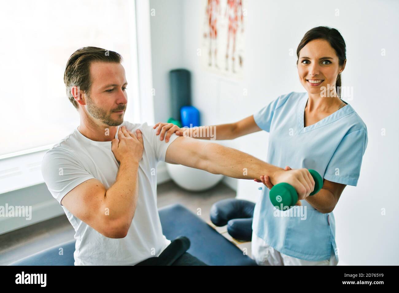 physiotherapist doing treatment with patient in bright office Stock ...