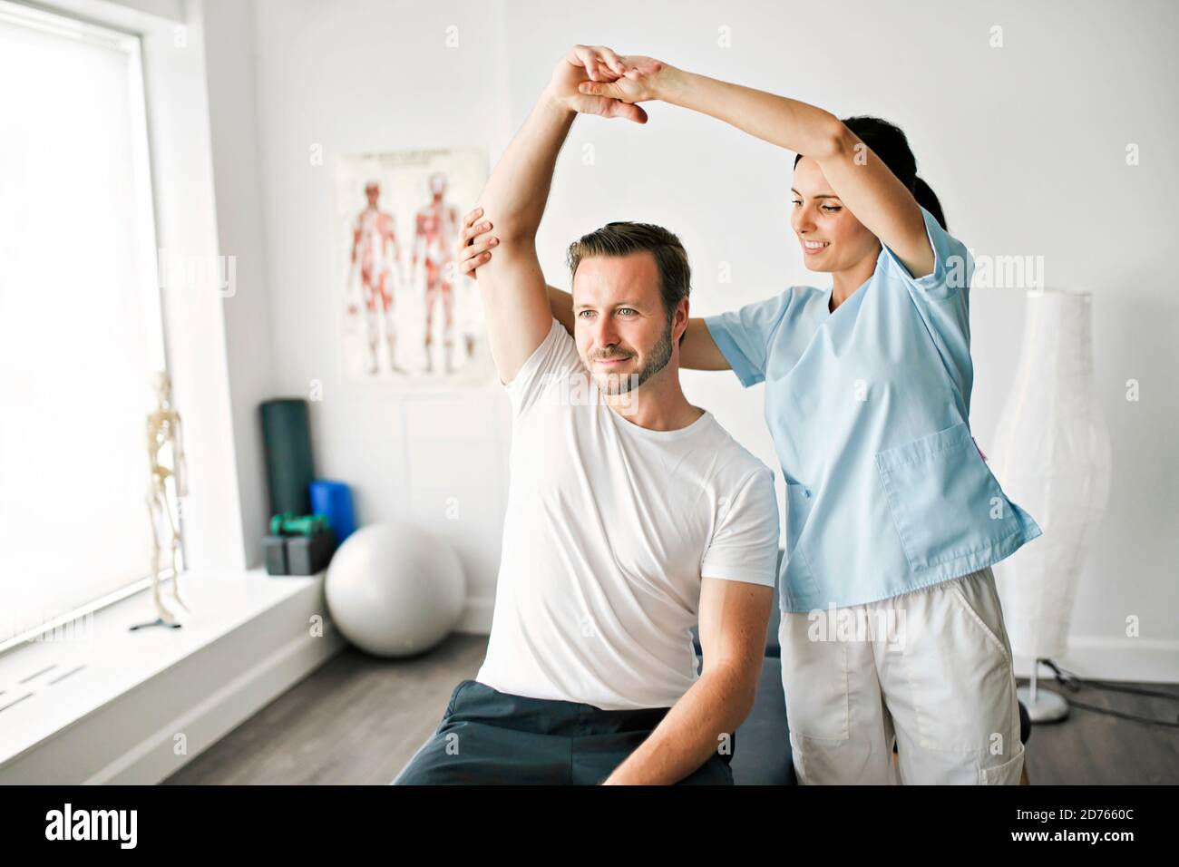 physiotherapist doing treatment with patient in bright office Stock ...