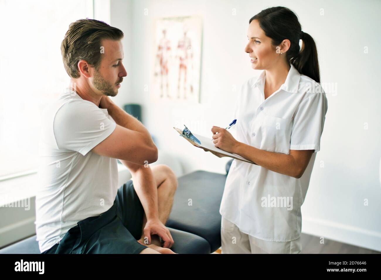 physiotherapist doing treatment with patient in bright office Stock ...
