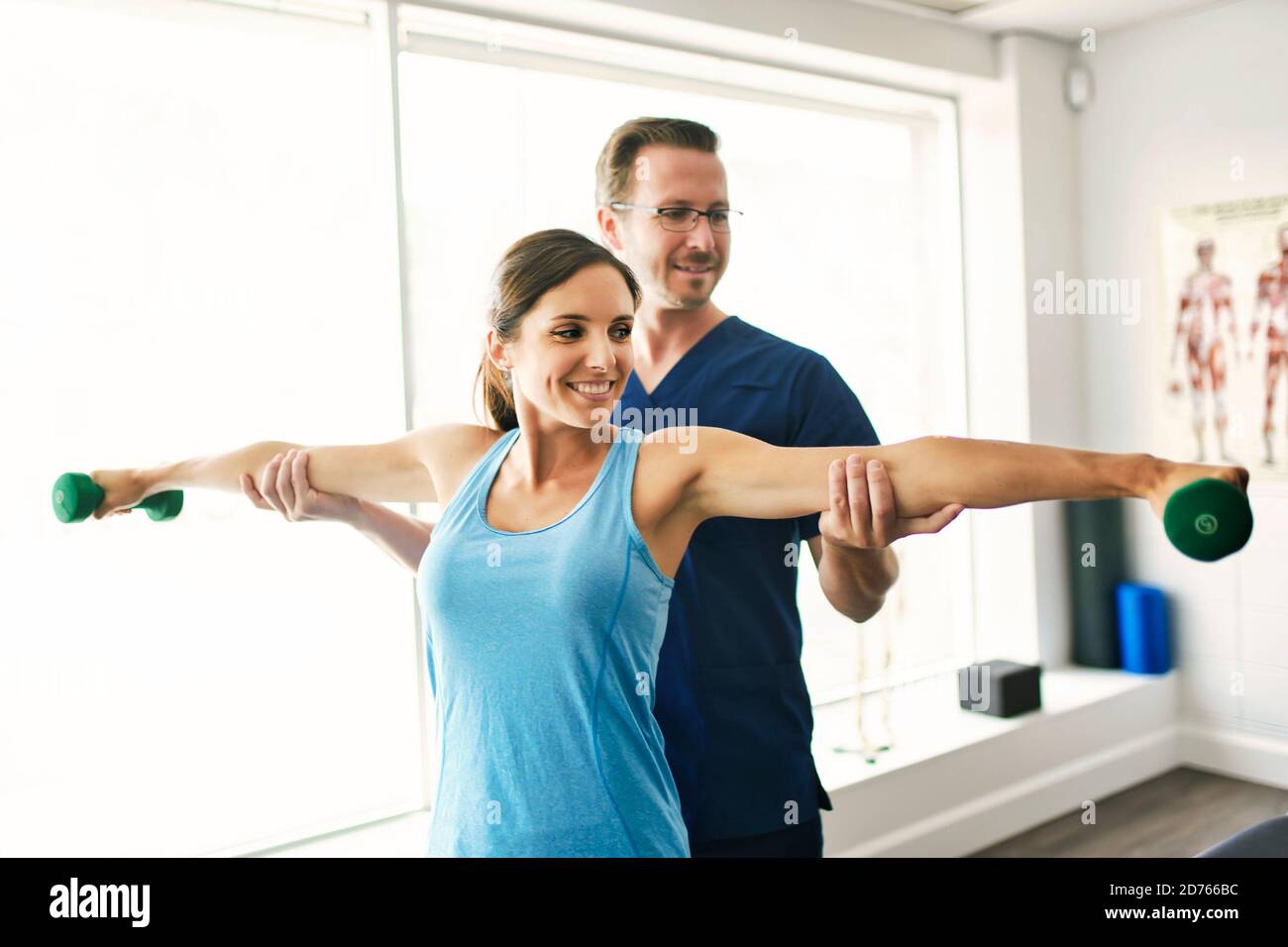 Male Physical Therapist Stretching a Female Patient Slowly Stock Photo ...