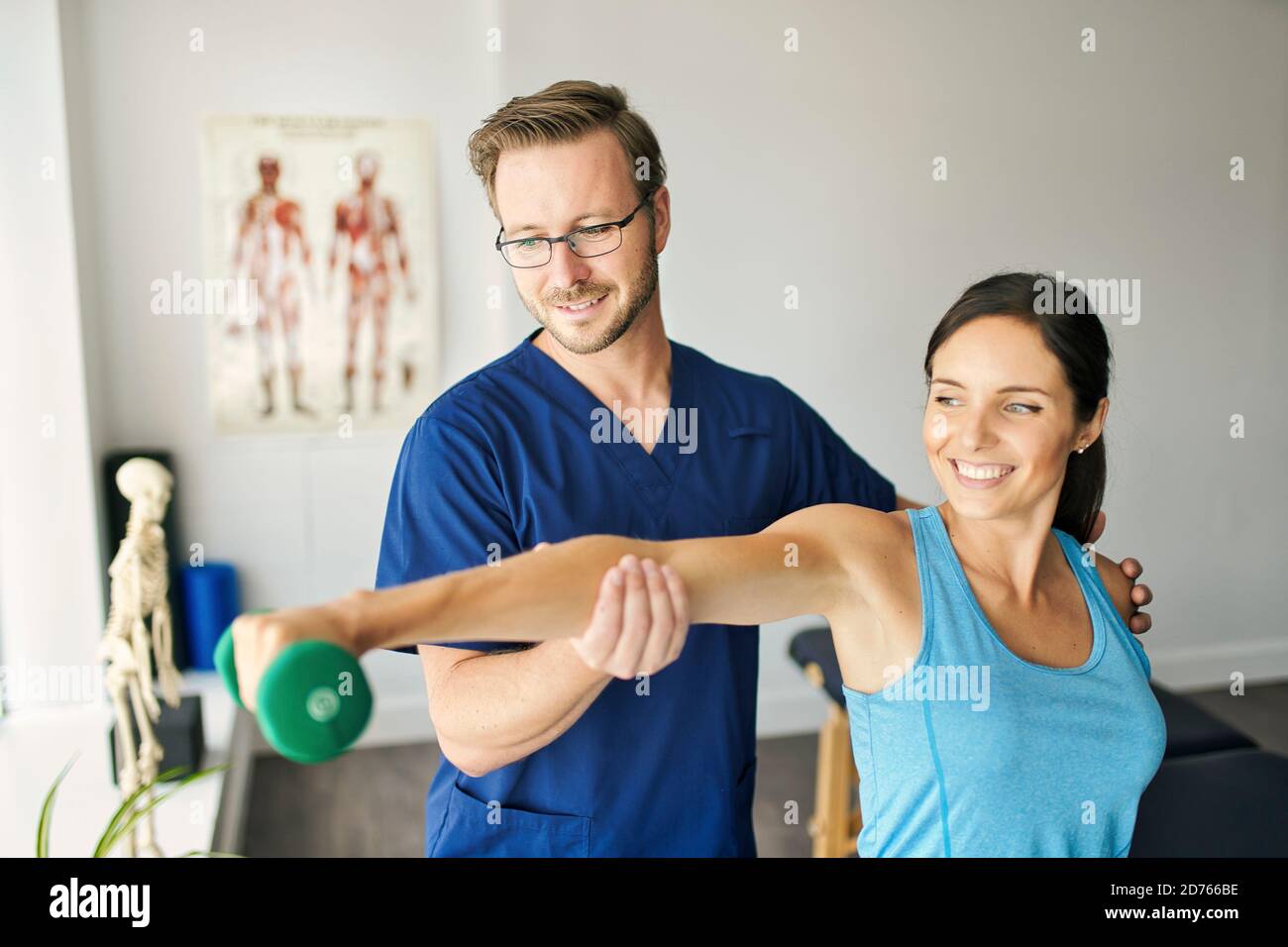 Male Physical Therapist Stretching a Female Patient Slowly Stock Photo ...