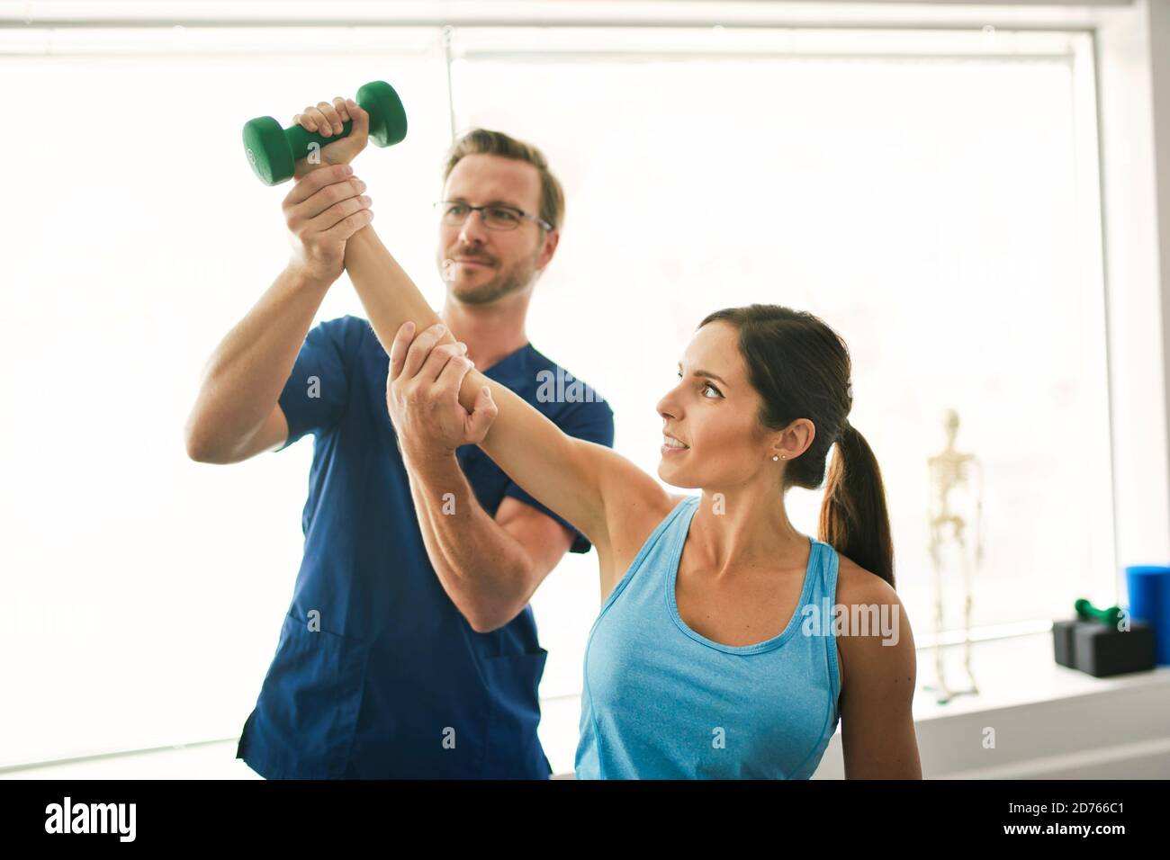Male Physical Therapist Stretching a Female Patient Slowly Stock Photo ...