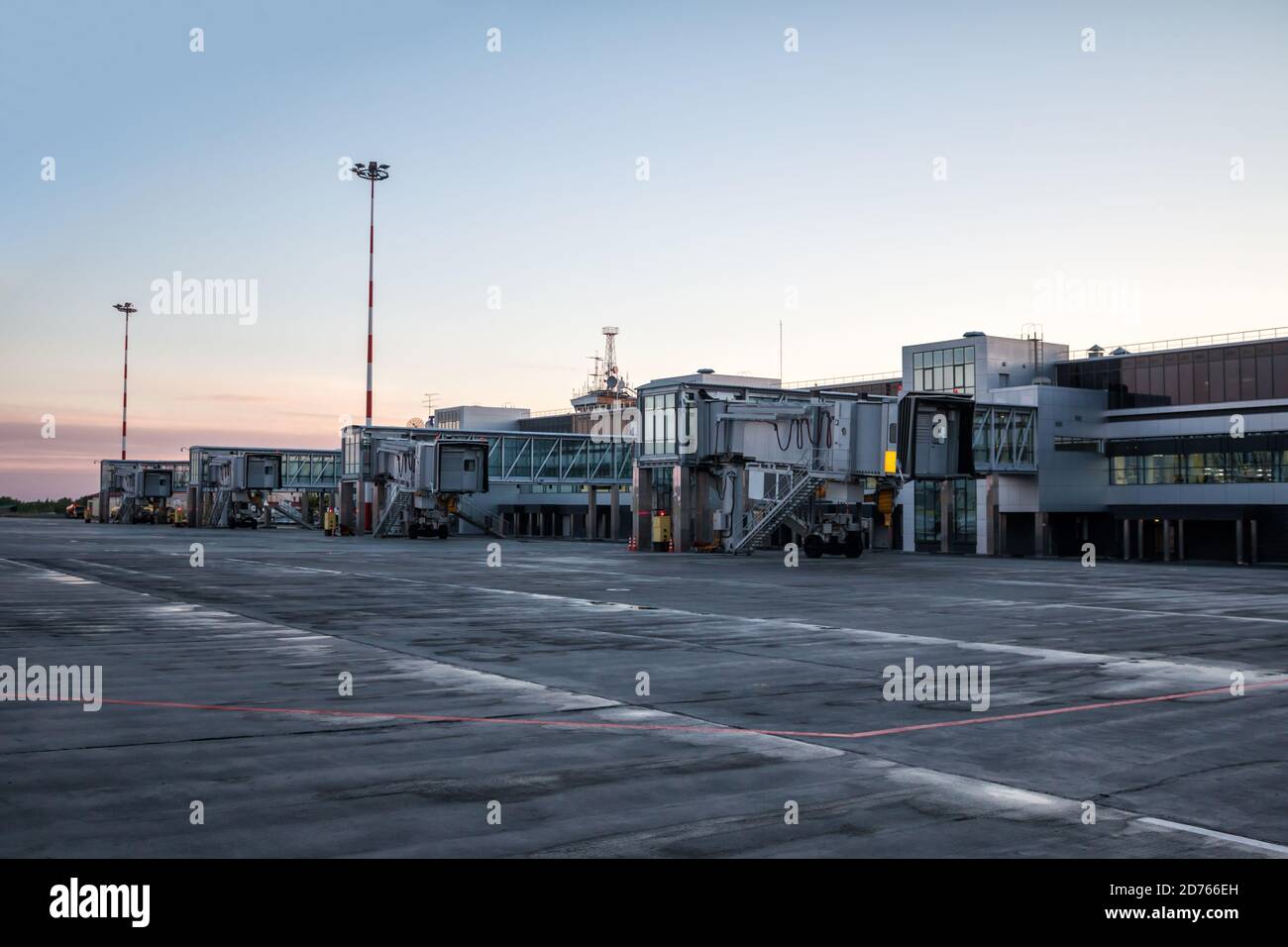 Empty jet bridges at the early morning airport apron Stock Photo - Alamy